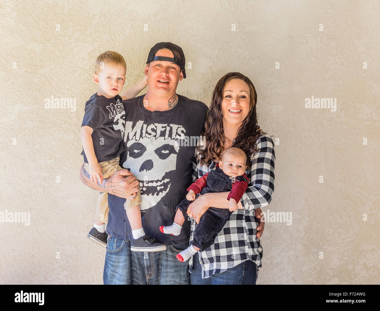 Portrait of a millennial generation family with two children and ...