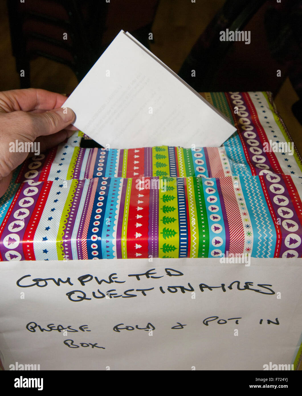 person putting questionnaire in box Stock Photo - Alamy