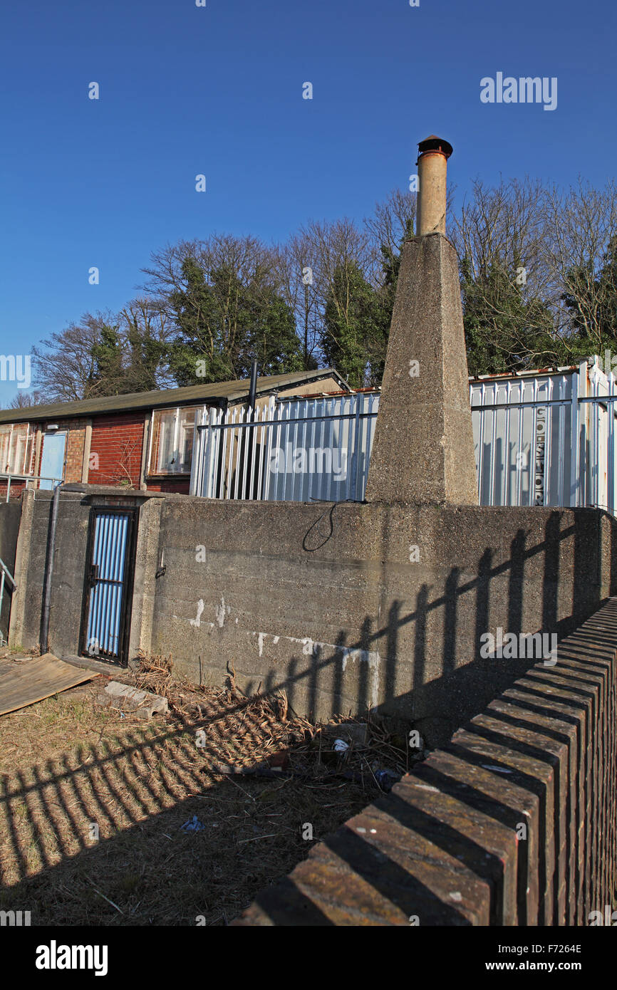A small section of a wartime bunker with access door and chimney ...