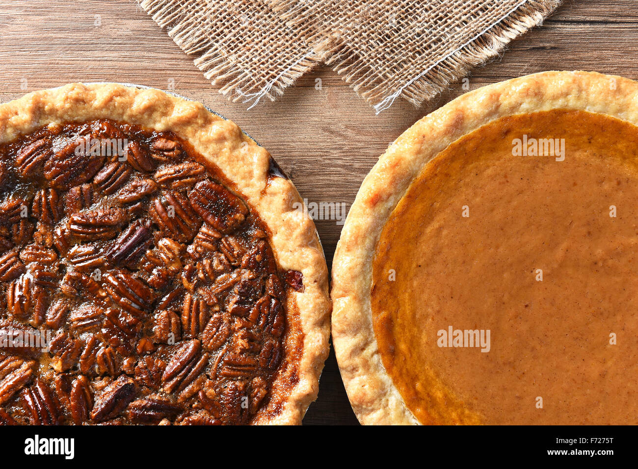 Closeup of two pies on a Thanksgiving holiday table. Pumpkin and pecan ...