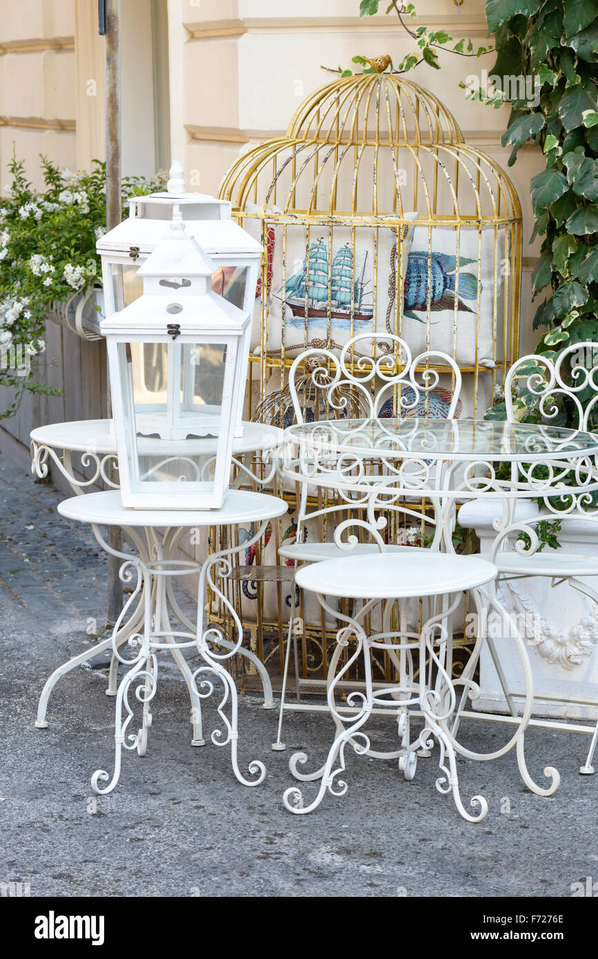 Some Iron white handmade Lanterns and chairs Stock Photo - Alamy