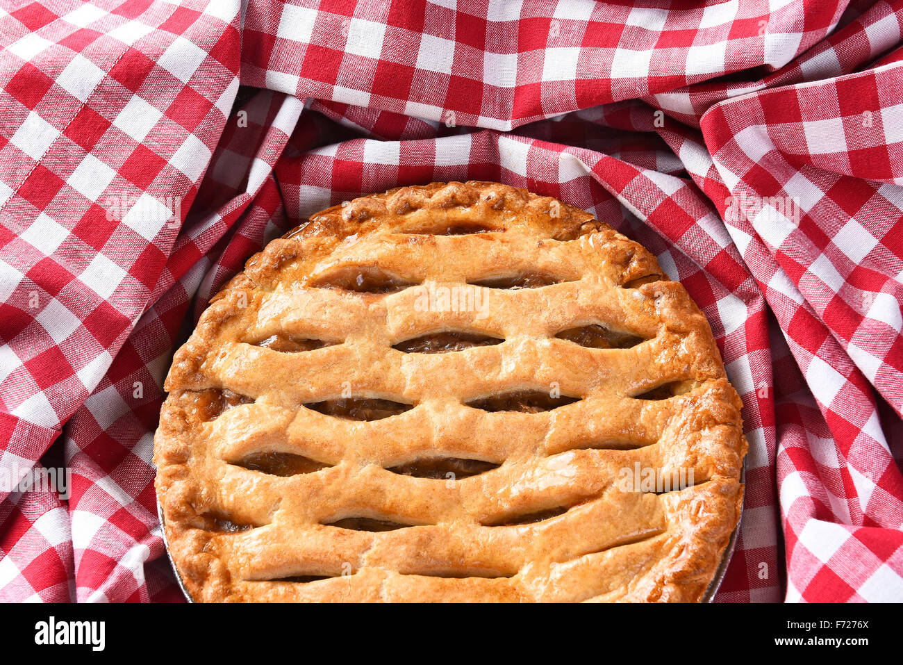 Closeup of a fresh baked Apple Pie surrounded by a red and white ...