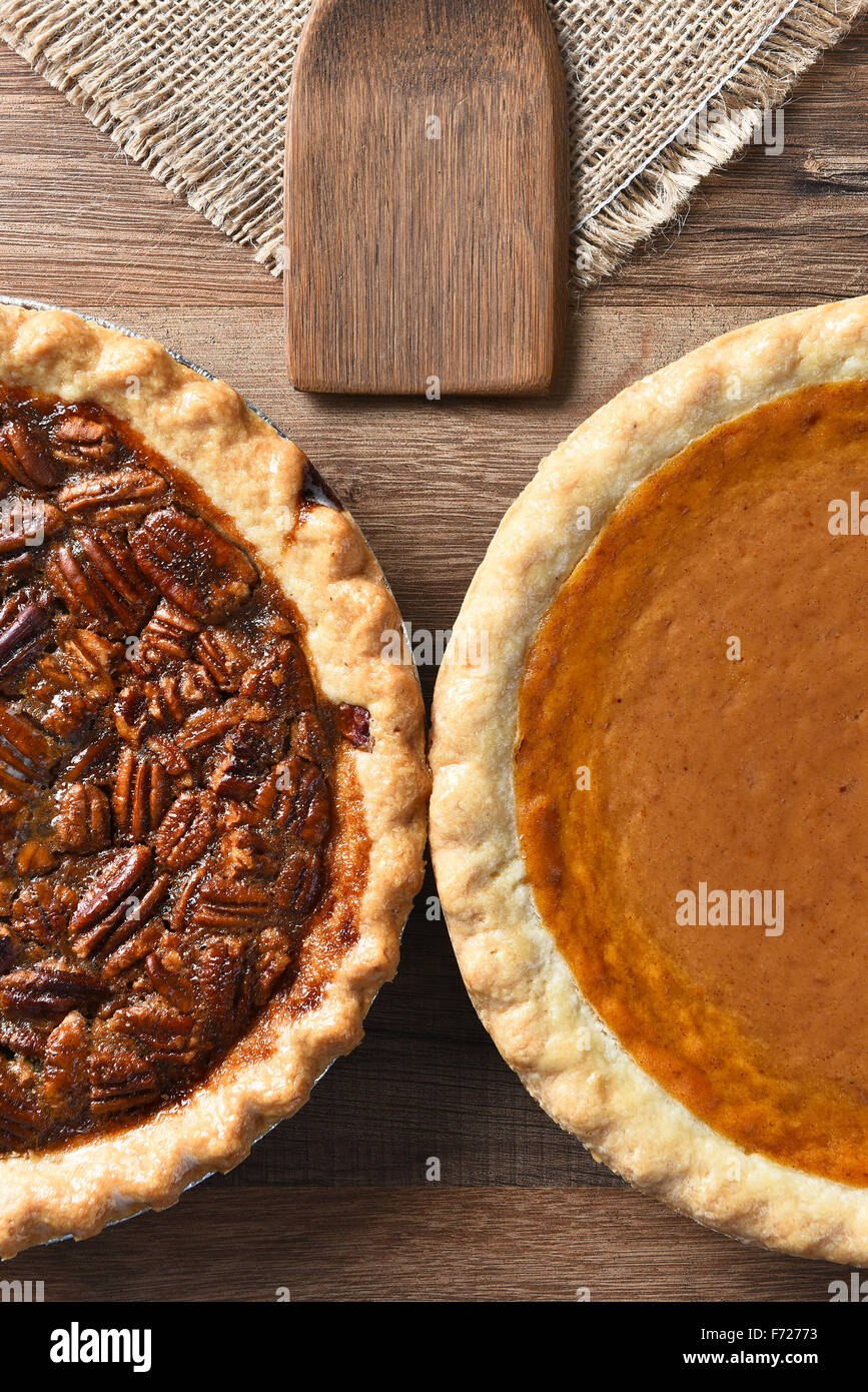 High angle vertical of half of a Pecan Pie and a Pumpkin Pie. The fresh ...