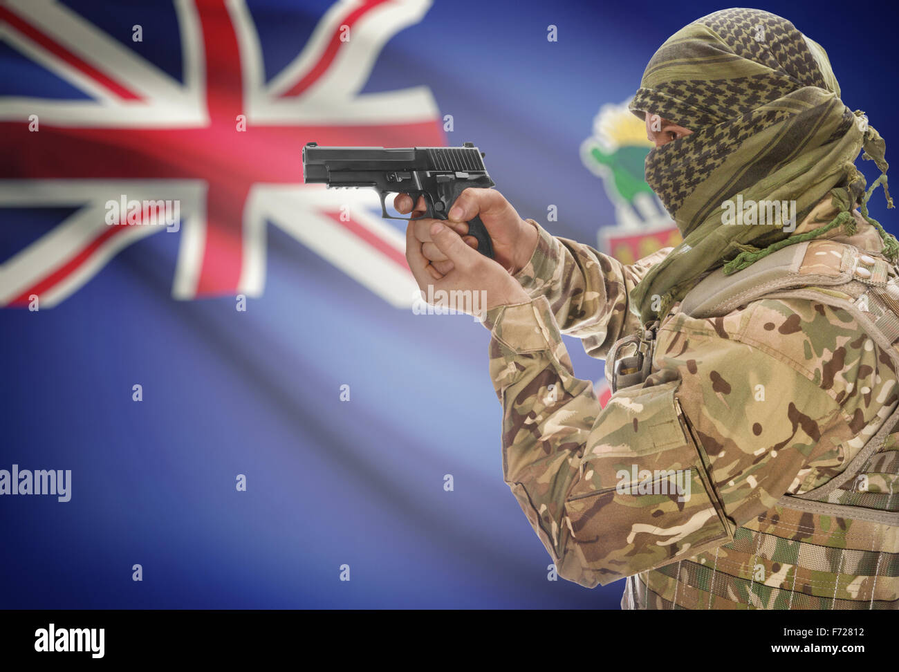 Male in muslim keffiyeh with gun in hand and national flag on ...