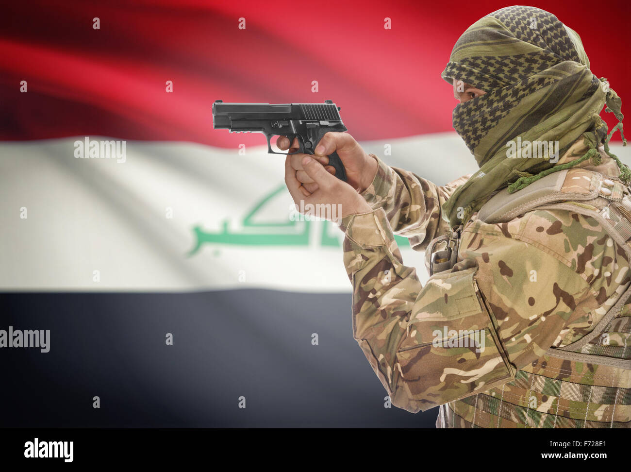 Male in muslim keffiyeh with gun in hand and national flag on ...