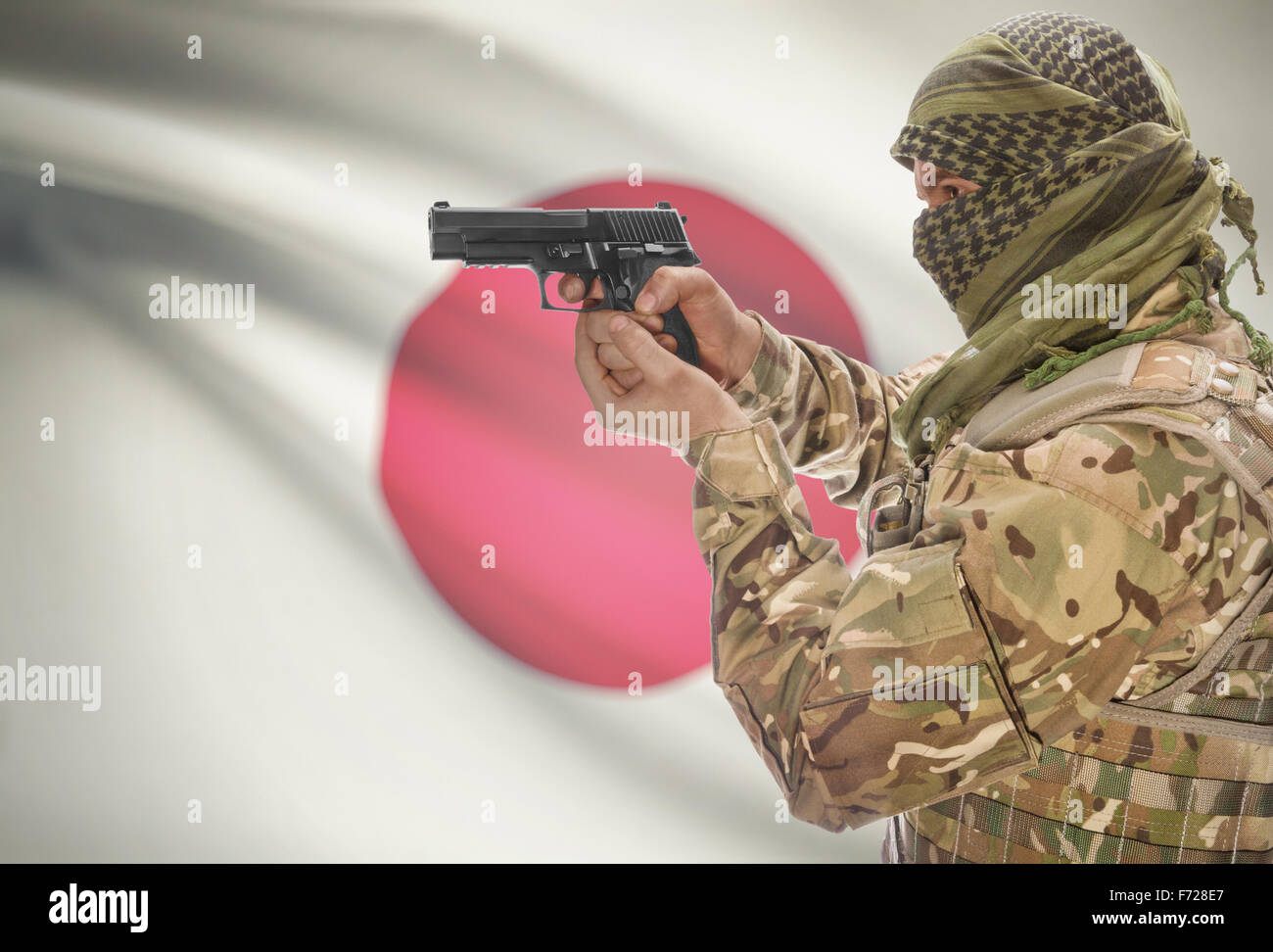 Male in muslim keffiyeh with gun in hand and national flag on ...