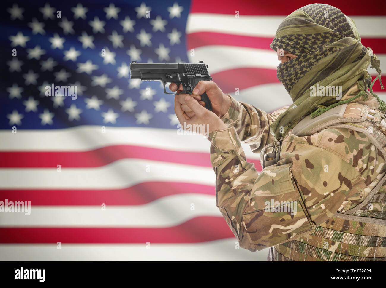 Male in muslim keffiyeh with gun in hand and national flag on ...