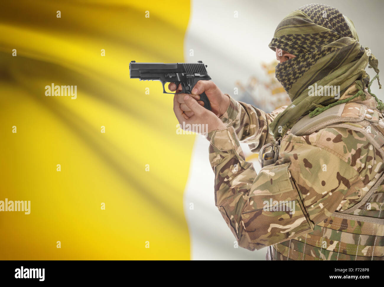 Male in muslim keffiyeh with gun in hand and national flag on ...