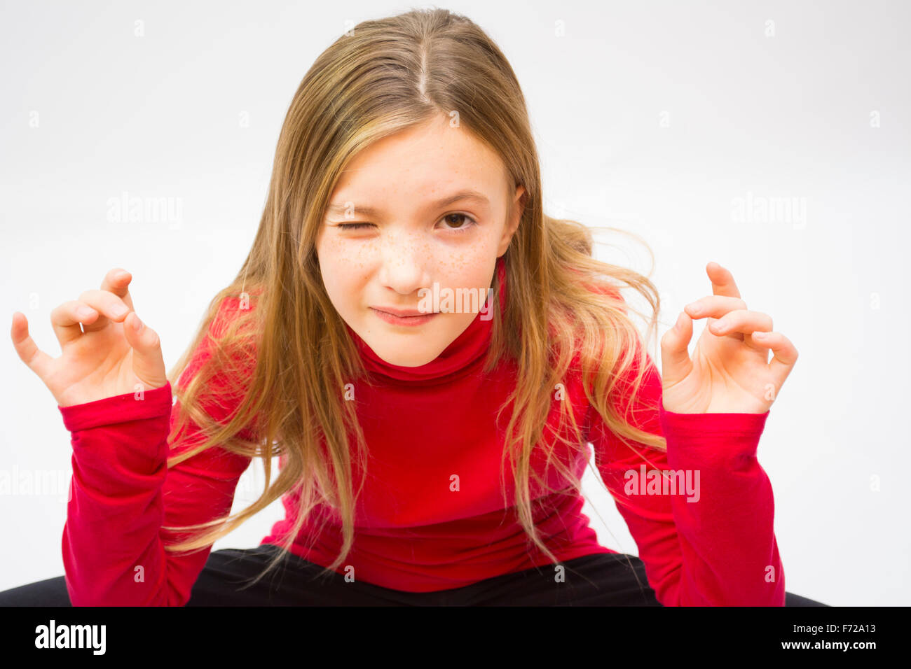 Winking girl in red Stock Photo - Alamy