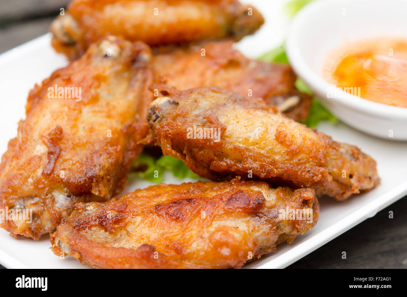 chicken wings on white dish wood background Stock Photo - Alamy