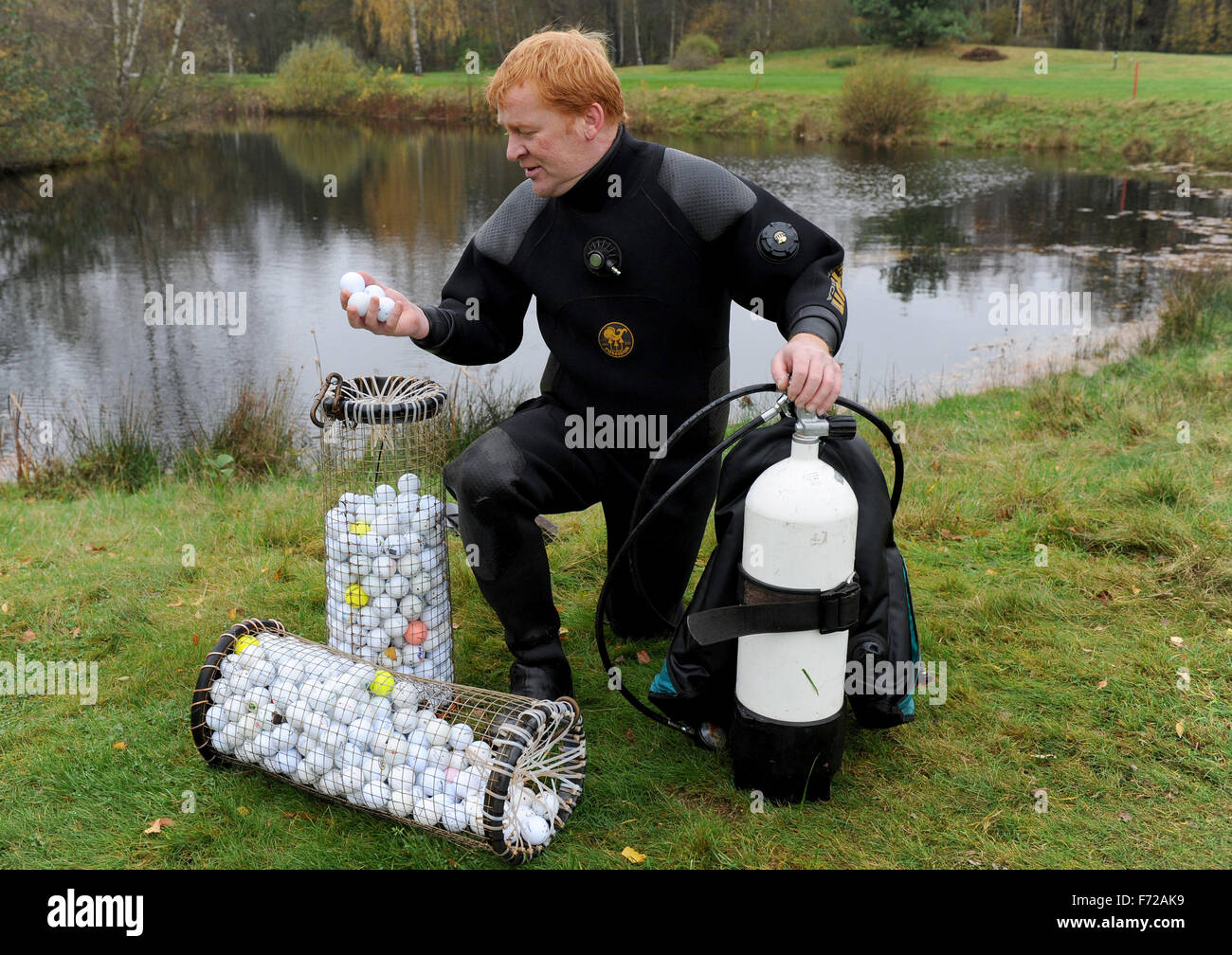 Bremen, Germany. 10th Nov, 2015. Golf ball diver Ralf Oestmann kneels ...
