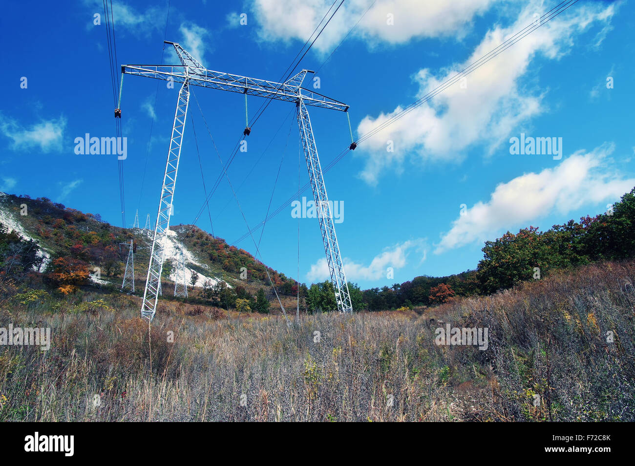 High voltage electricity pylon system on cloud background Stock Photo ...