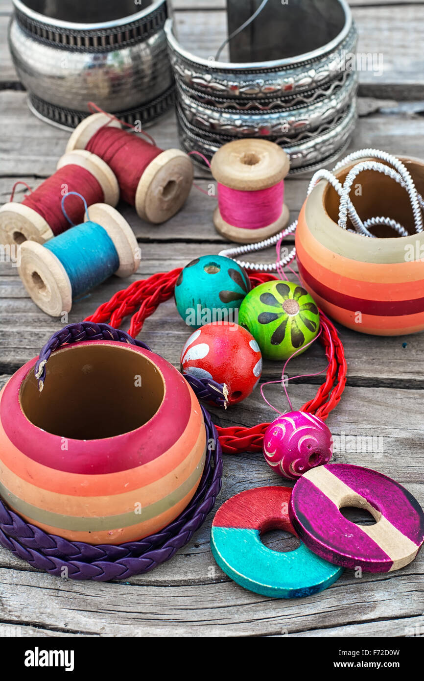Stylish beads and spools of thread on wooden background Stock Photo - Alamy