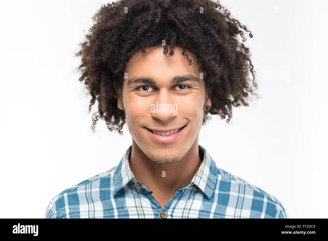 Portrait of a smiling afro american man with curly hair looking at camera isolated on a white ...