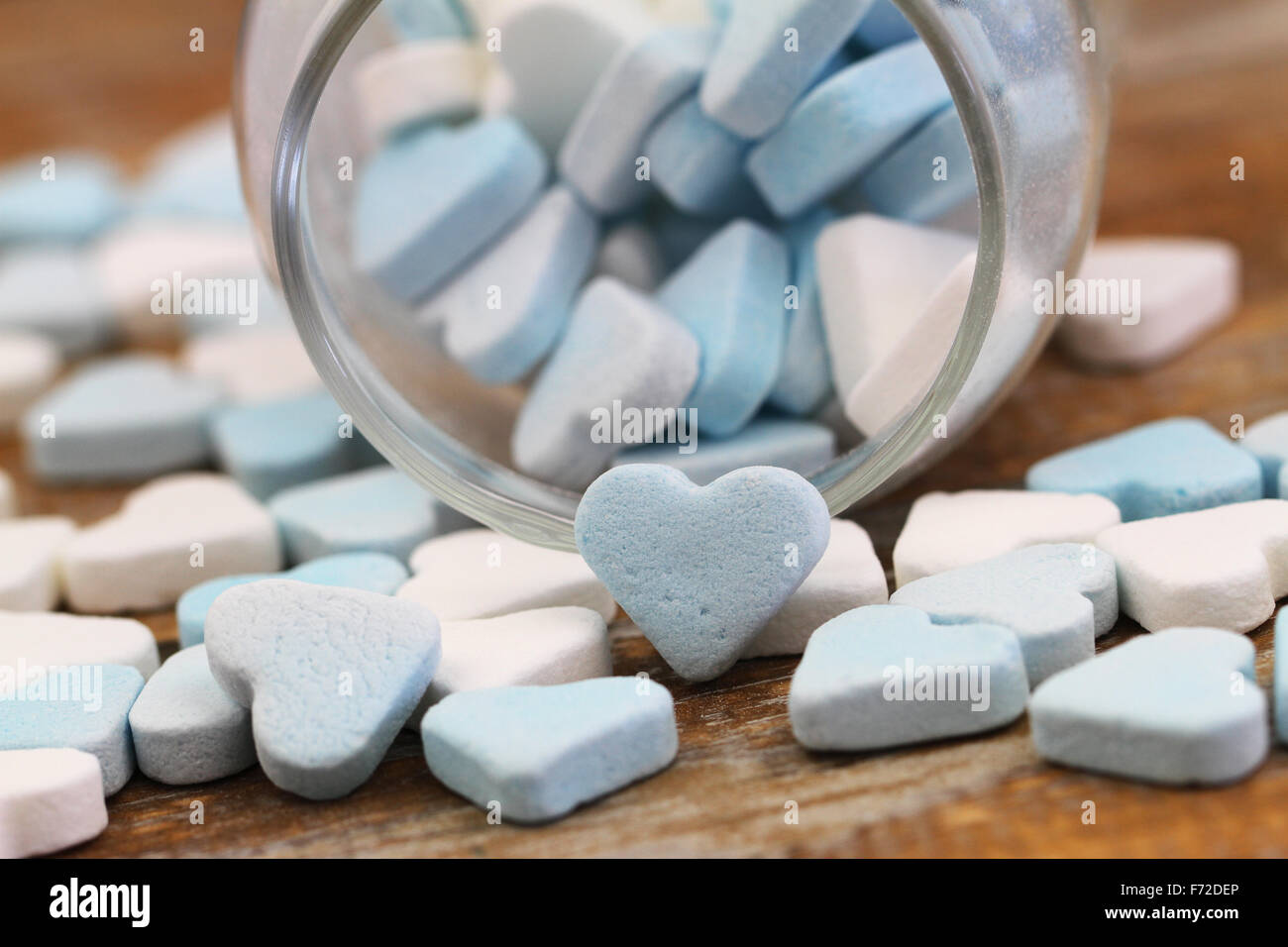 White and blue sugar hearts scattered on wooden surface Stock Photo - Alamy