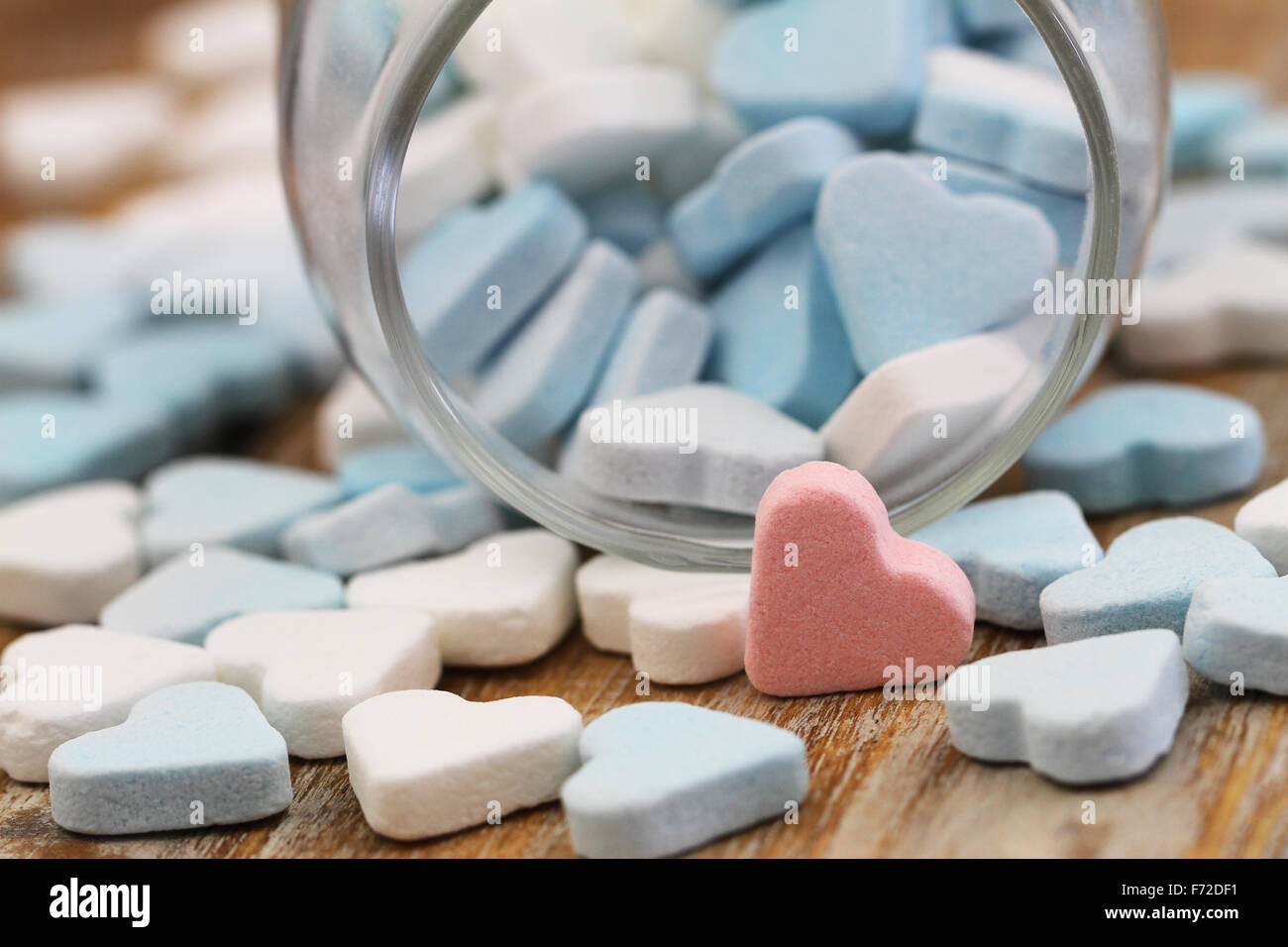 Pink sugar heart among scattered white and blue sugar hearts Stock ...