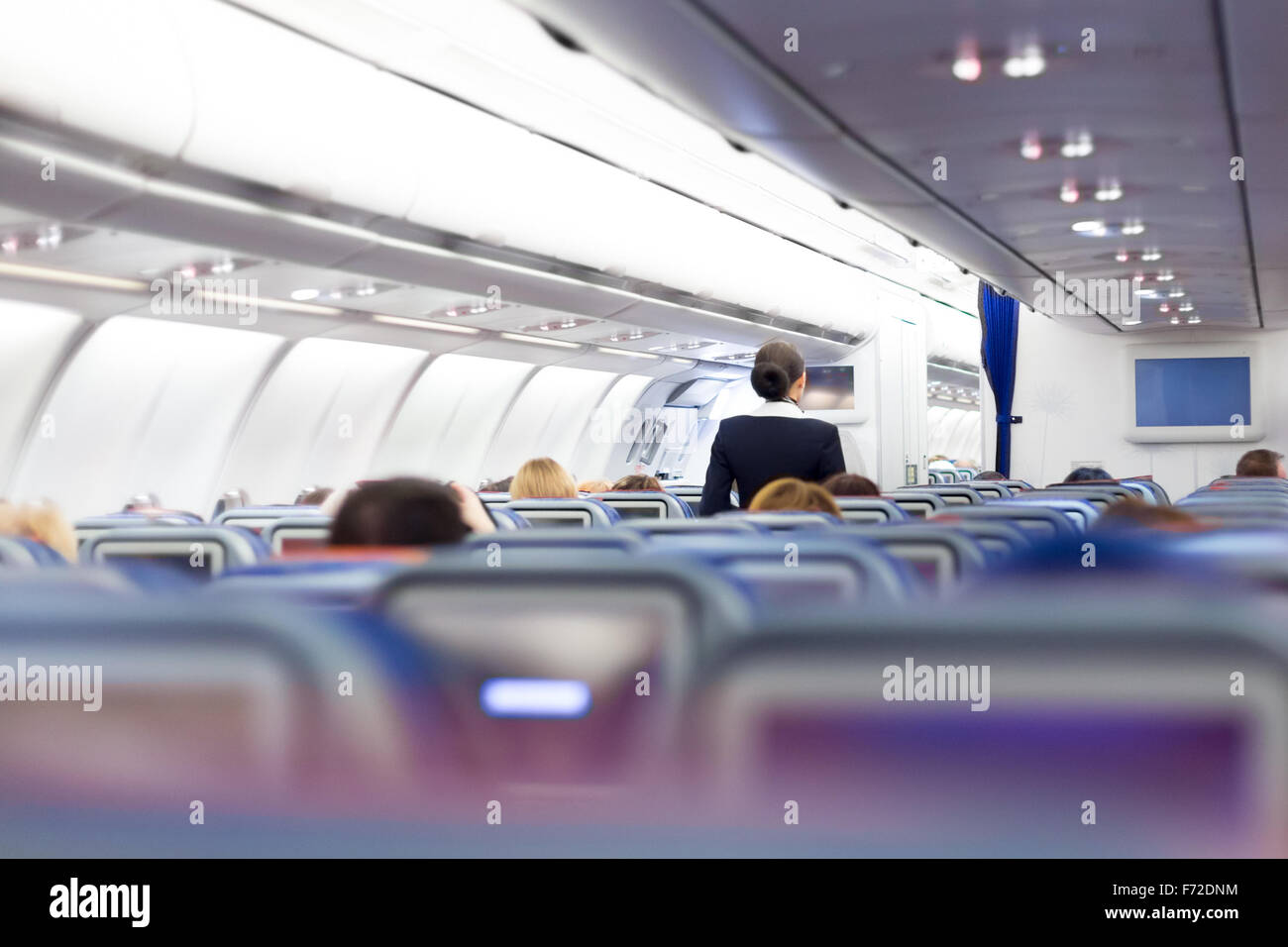Interior of airplane with passengers on seats Stock Photo - Alamy