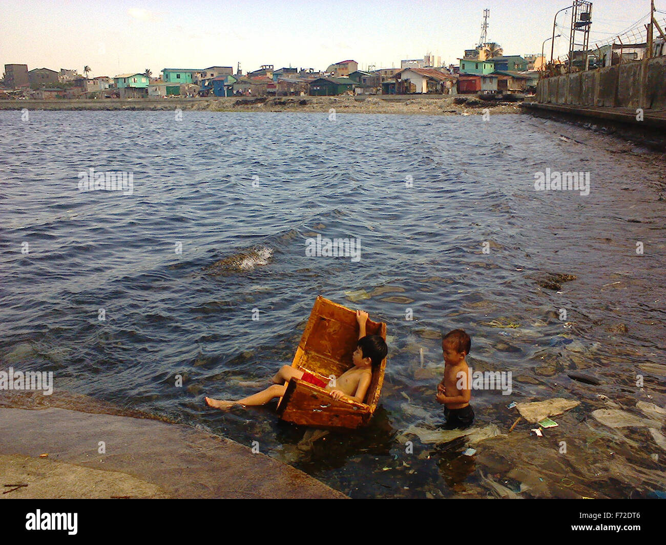 Navotas City, Philippines. 24th Nov, 2015. Filipino boys swim along the ...