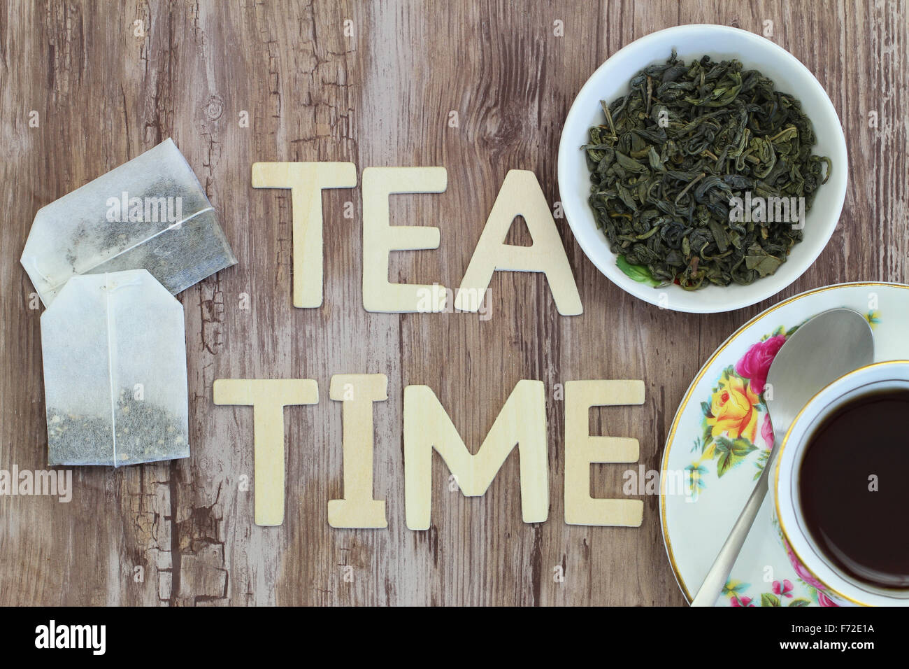 Tea time written with wooden letters, tea bags and dried tea leaves ...