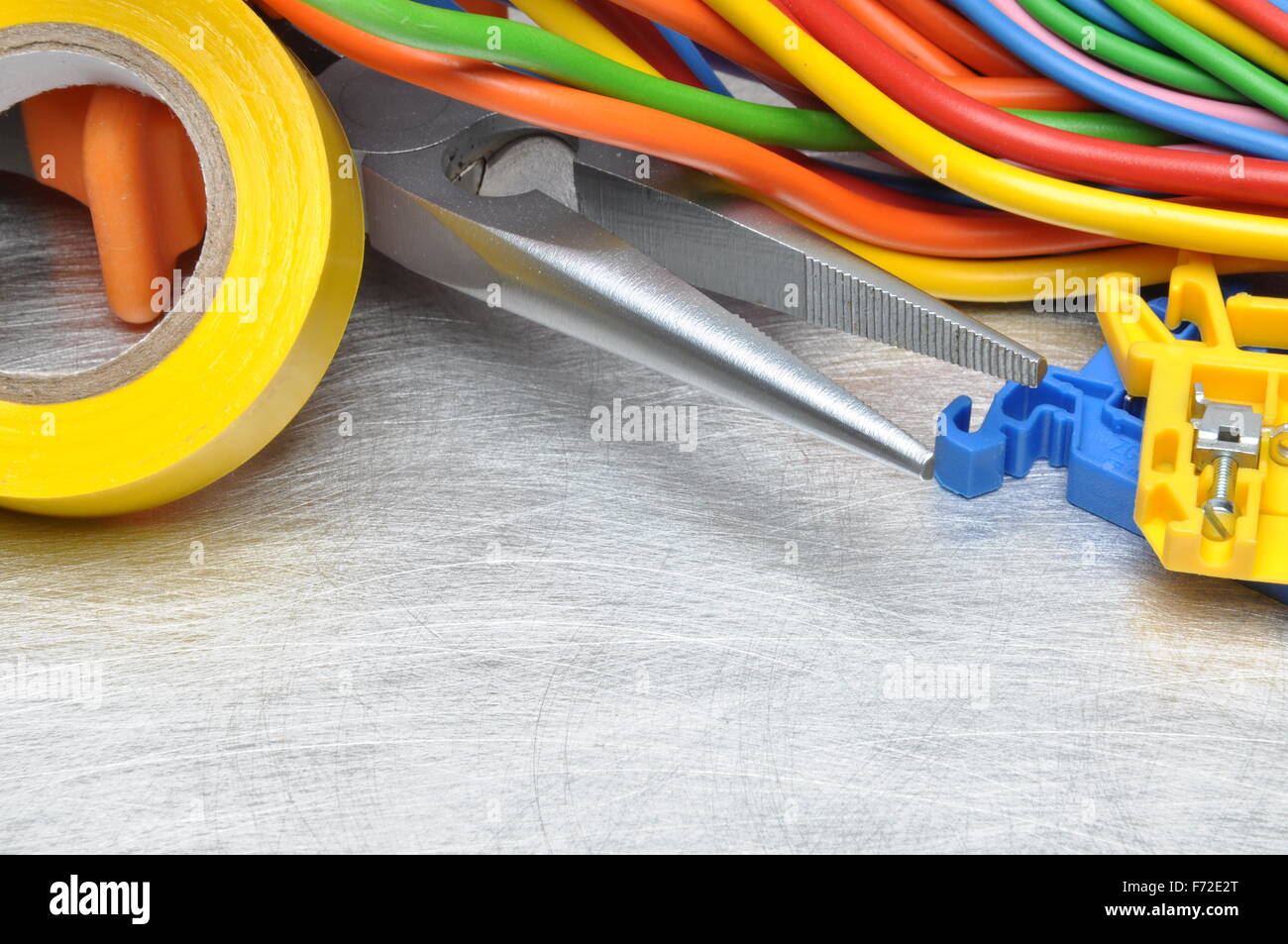 Set of electrical tools and cables on metal surface with place for text ...