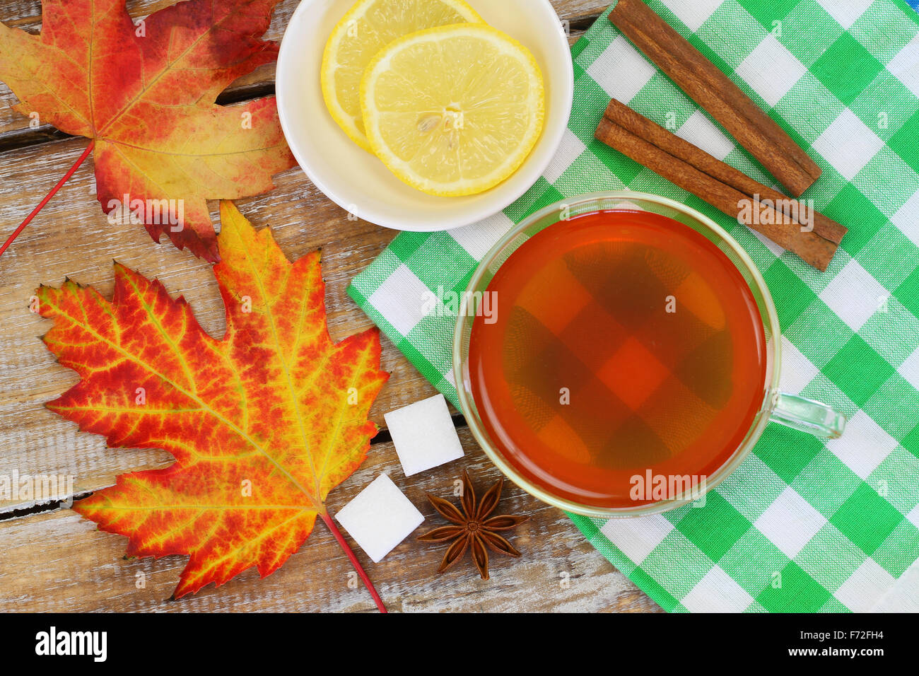 Colorful autumn leaves and lemon tea on checkered cloth Stock Photo - Alamy