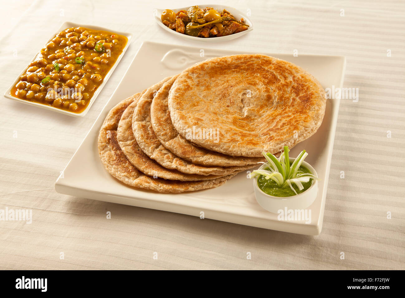 Bran paratha puri served with chickpeas cholay and pickle chutney Stock ...