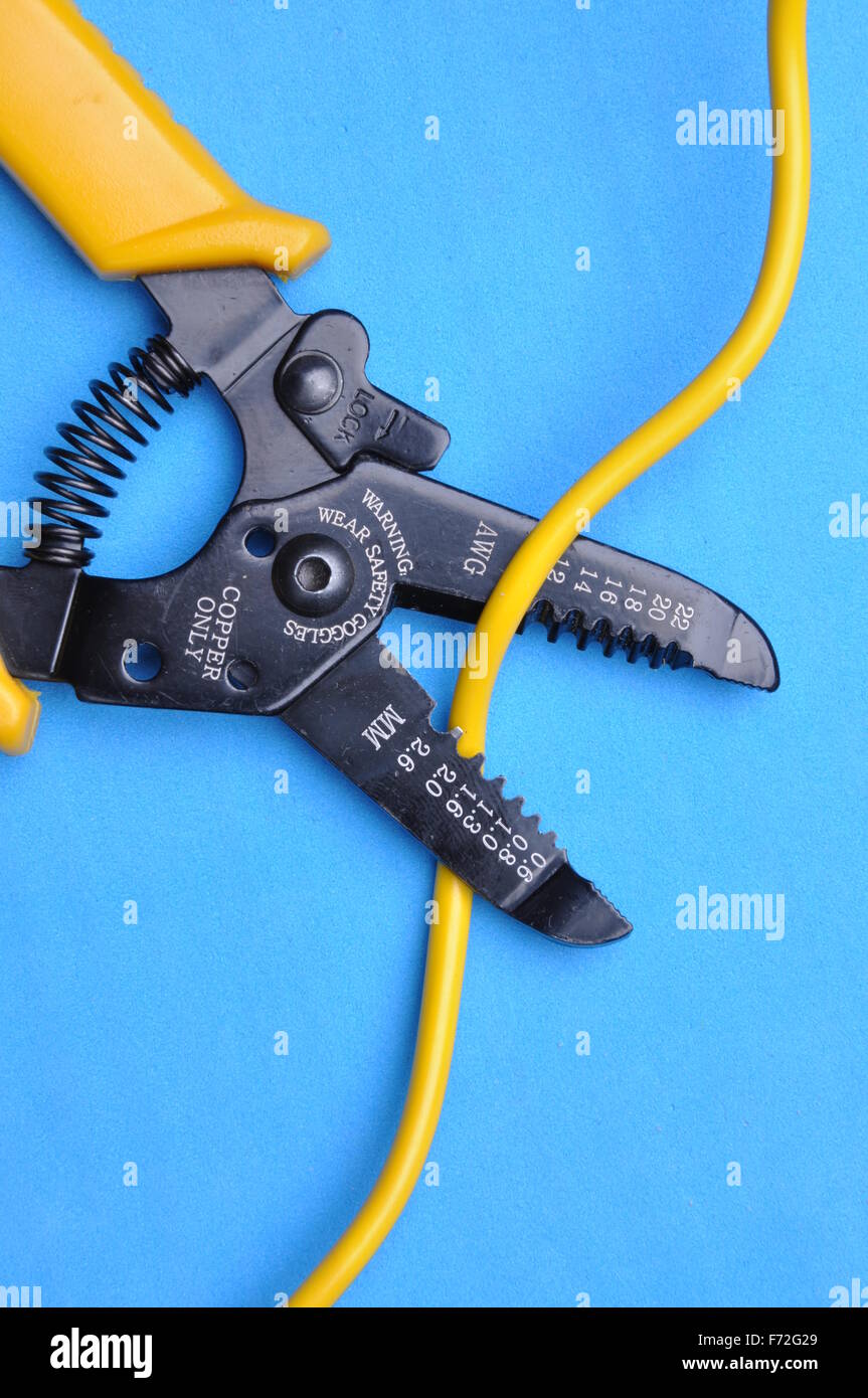 Wire stripper and cable on blue background Stock Photo - Alamy