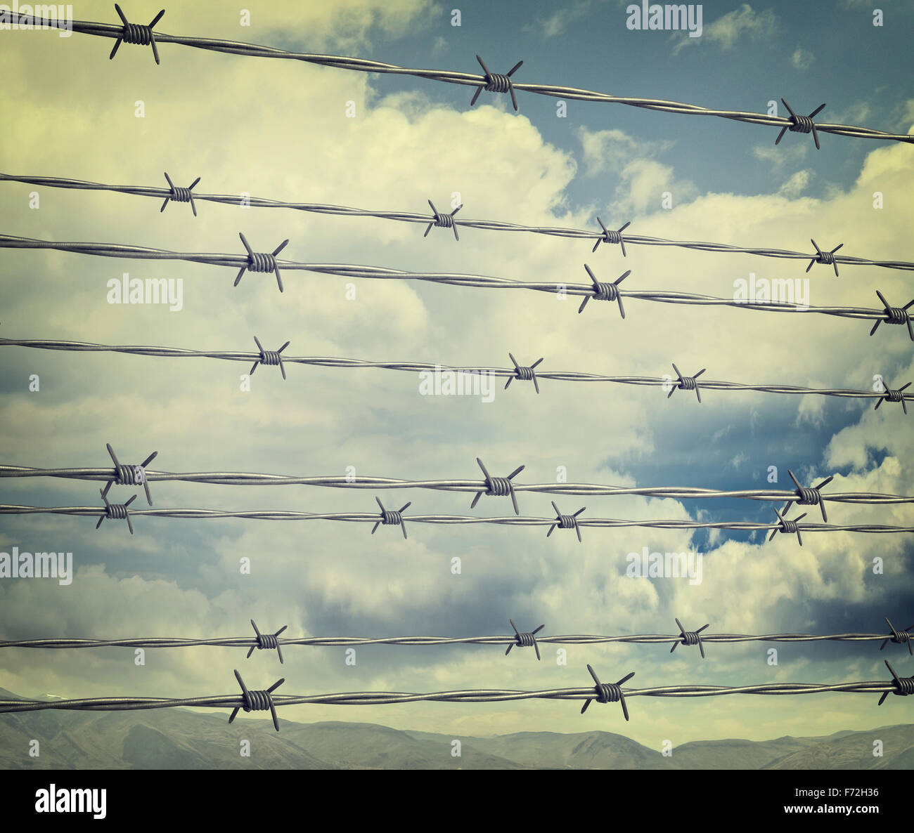 barbed wire background and cloudy sky Stock Photo - Alamy