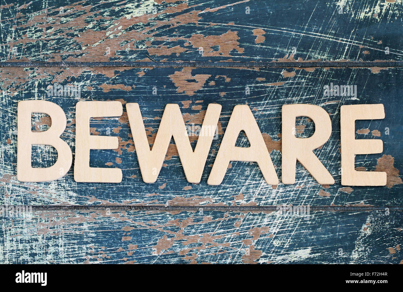 Word beware written with wooden letters on rustic surface Stock Photo ...
