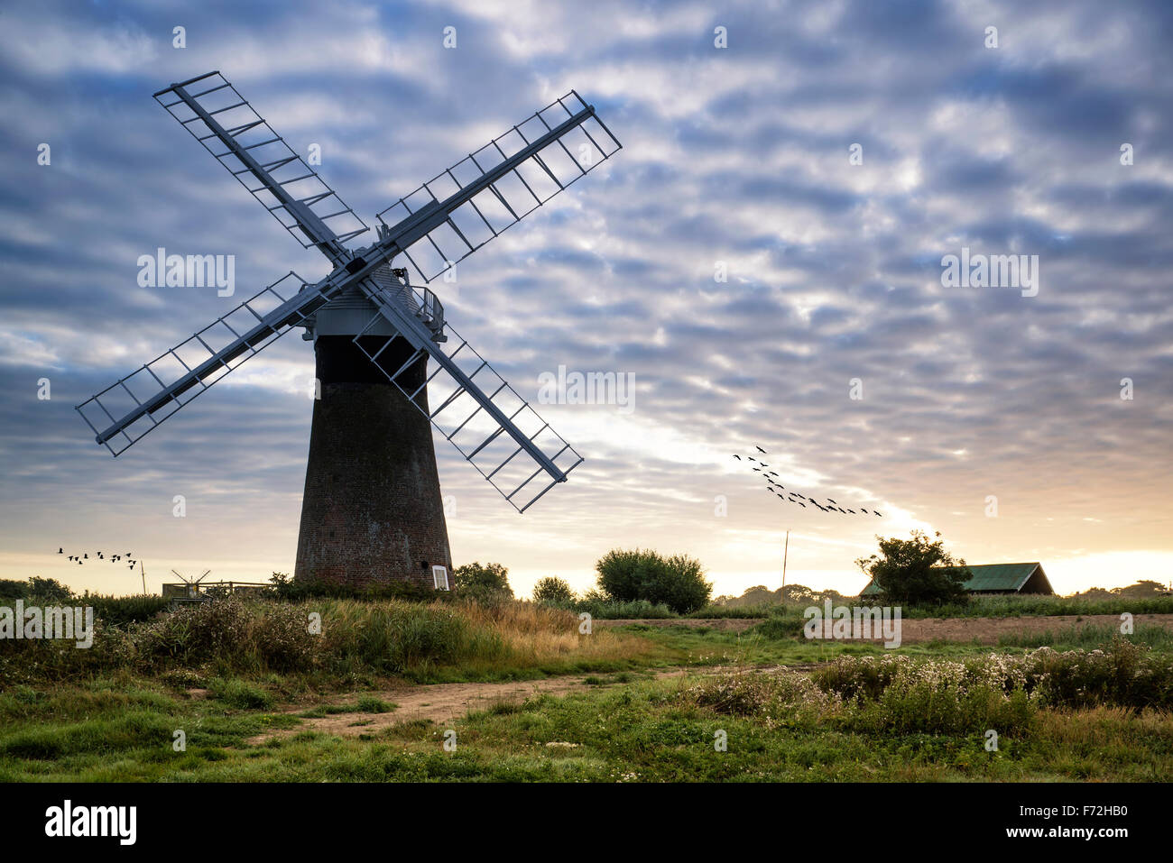 Old windpump windmill in English countryside landscape early morning ...