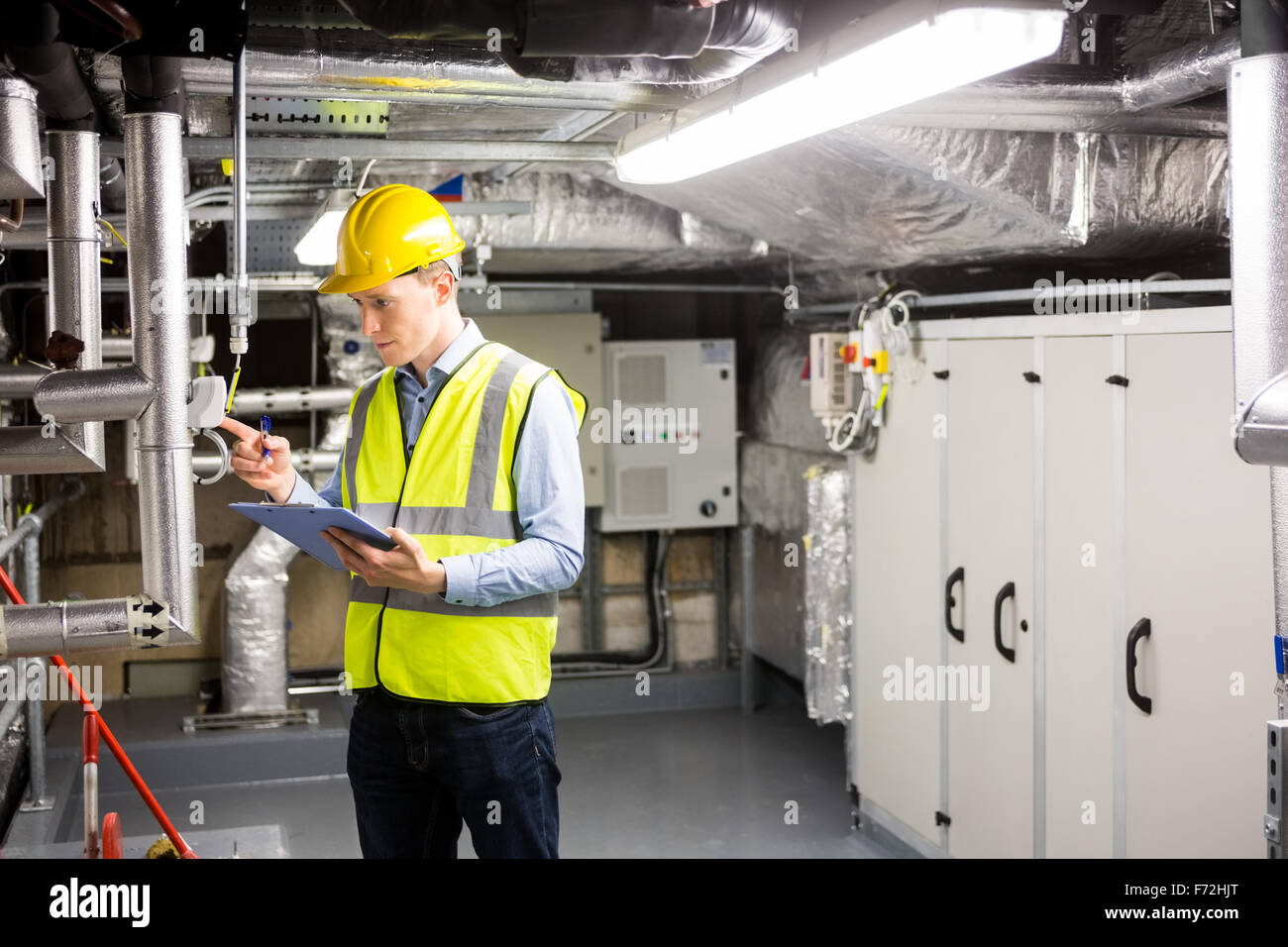 Engineer checking the temperature pipes Stock Photo - Alamy
