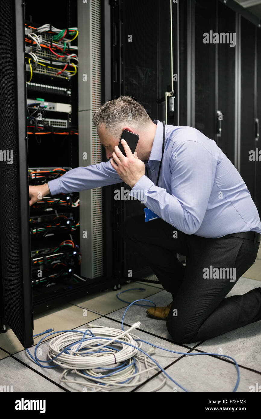 Technician working on broken server Stock Photo - Alamy