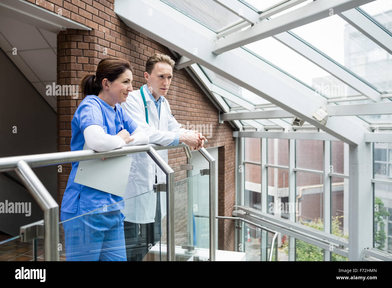 Medical team standing and talking Stock Photo - Alamy