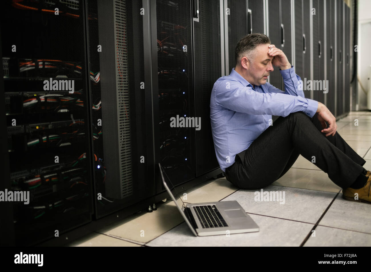Technician feeling the pressure in server room Stock Photo - Alamy