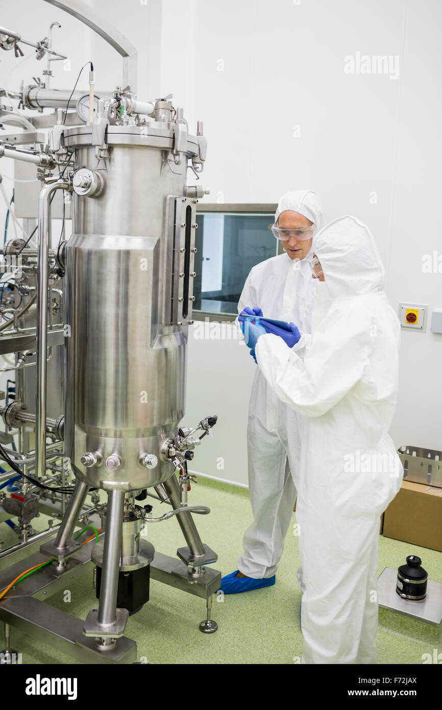 Scientists working with large vat Stock Photo - Alamy