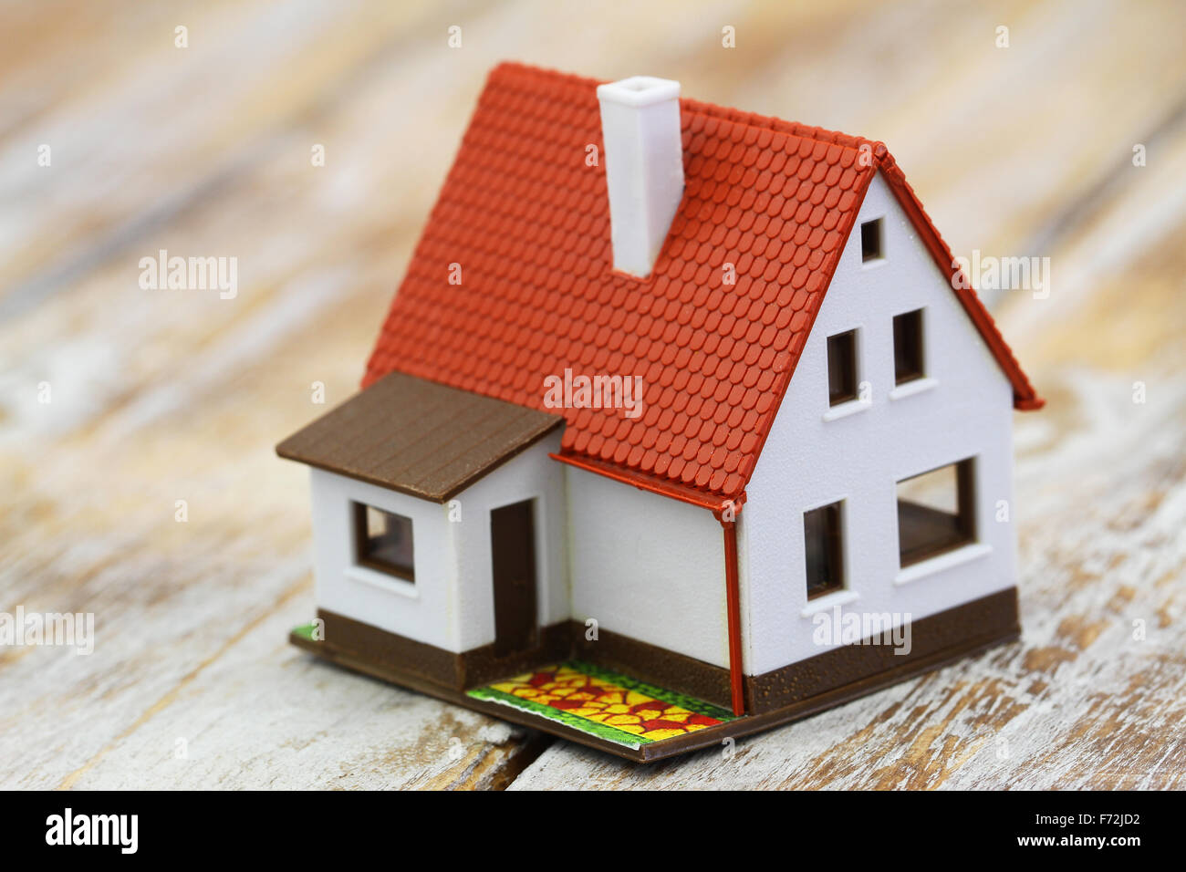 Model house on rustic wooden surface with copy space Stock Photo - Alamy