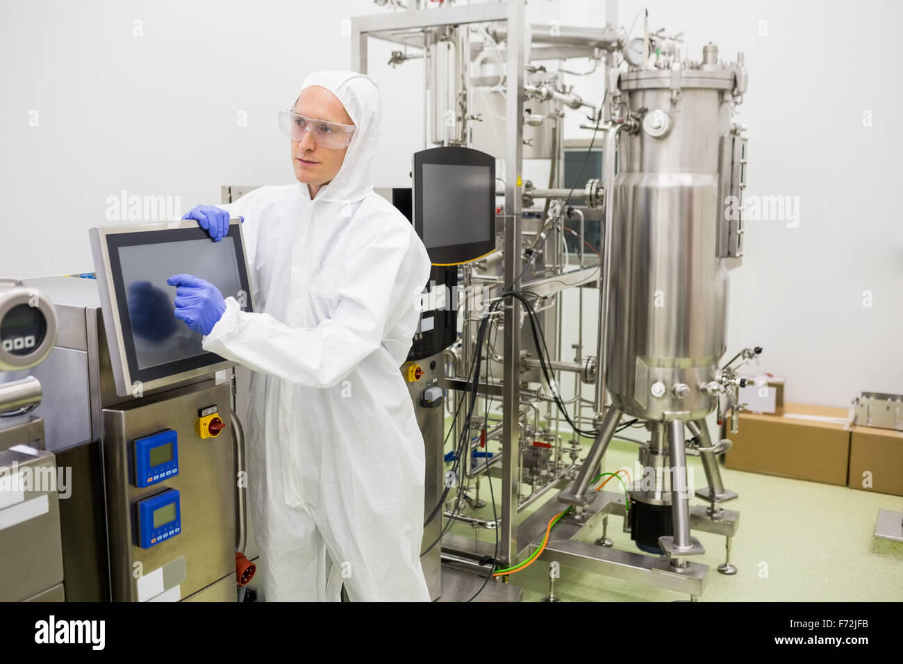 Scientist using screen to control vats Stock Photo - Alamy