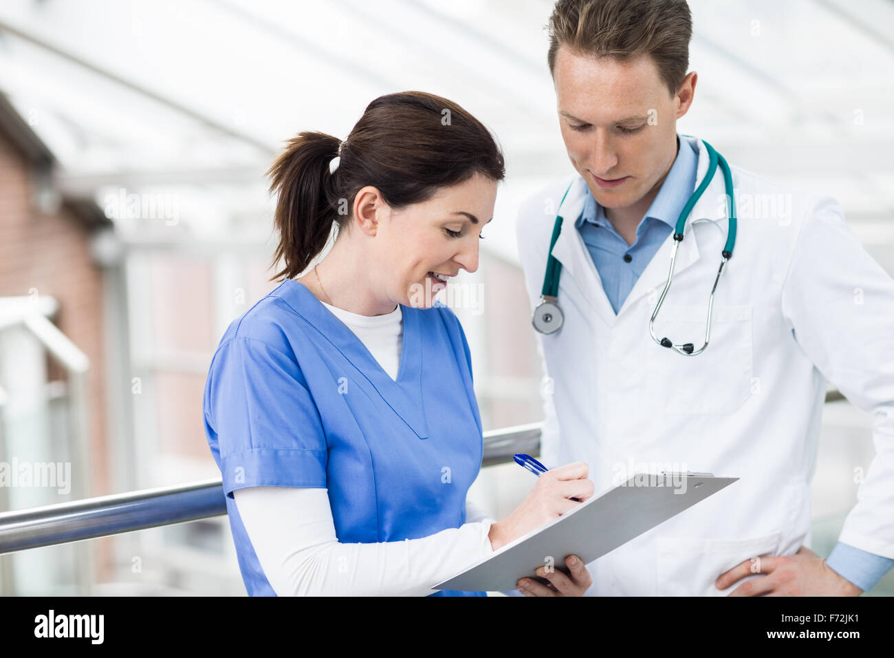 Medical team standing and talking Stock Photo - Alamy