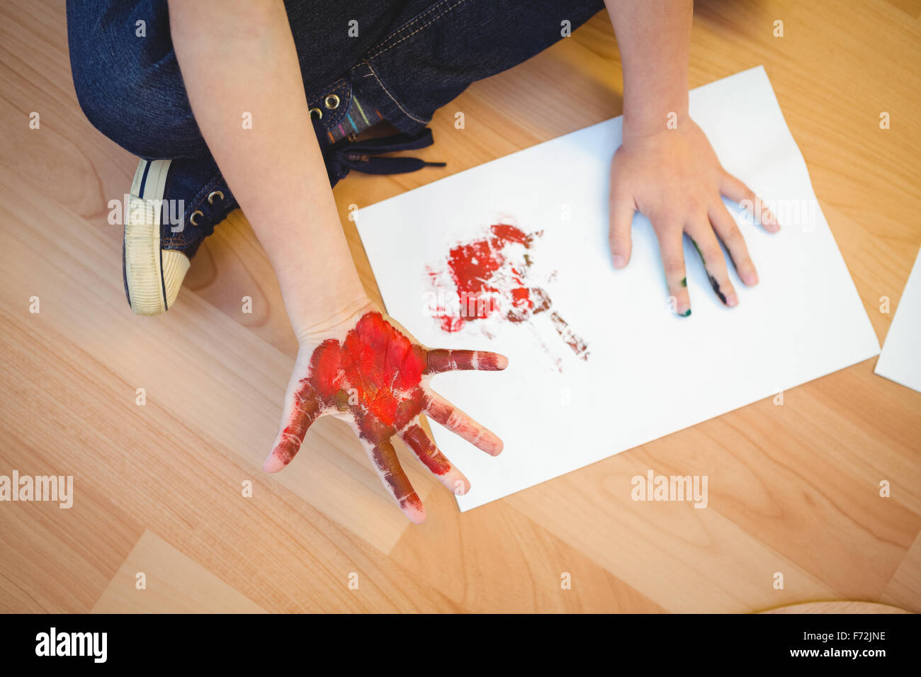 Boy showing his red painted hand Stock Photo - Alamy