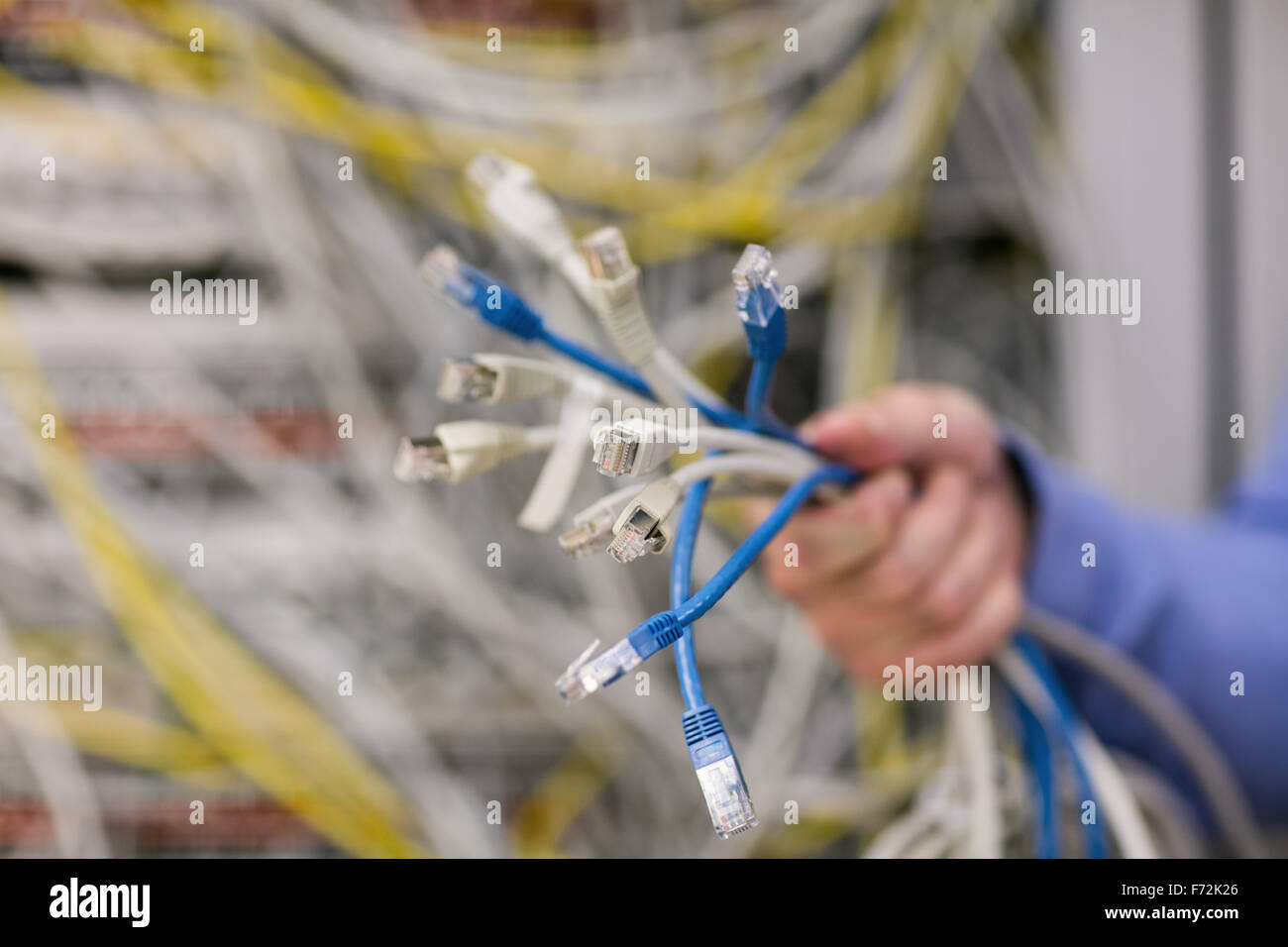 Technician holding bunch of cables Stock Photo - Alamy