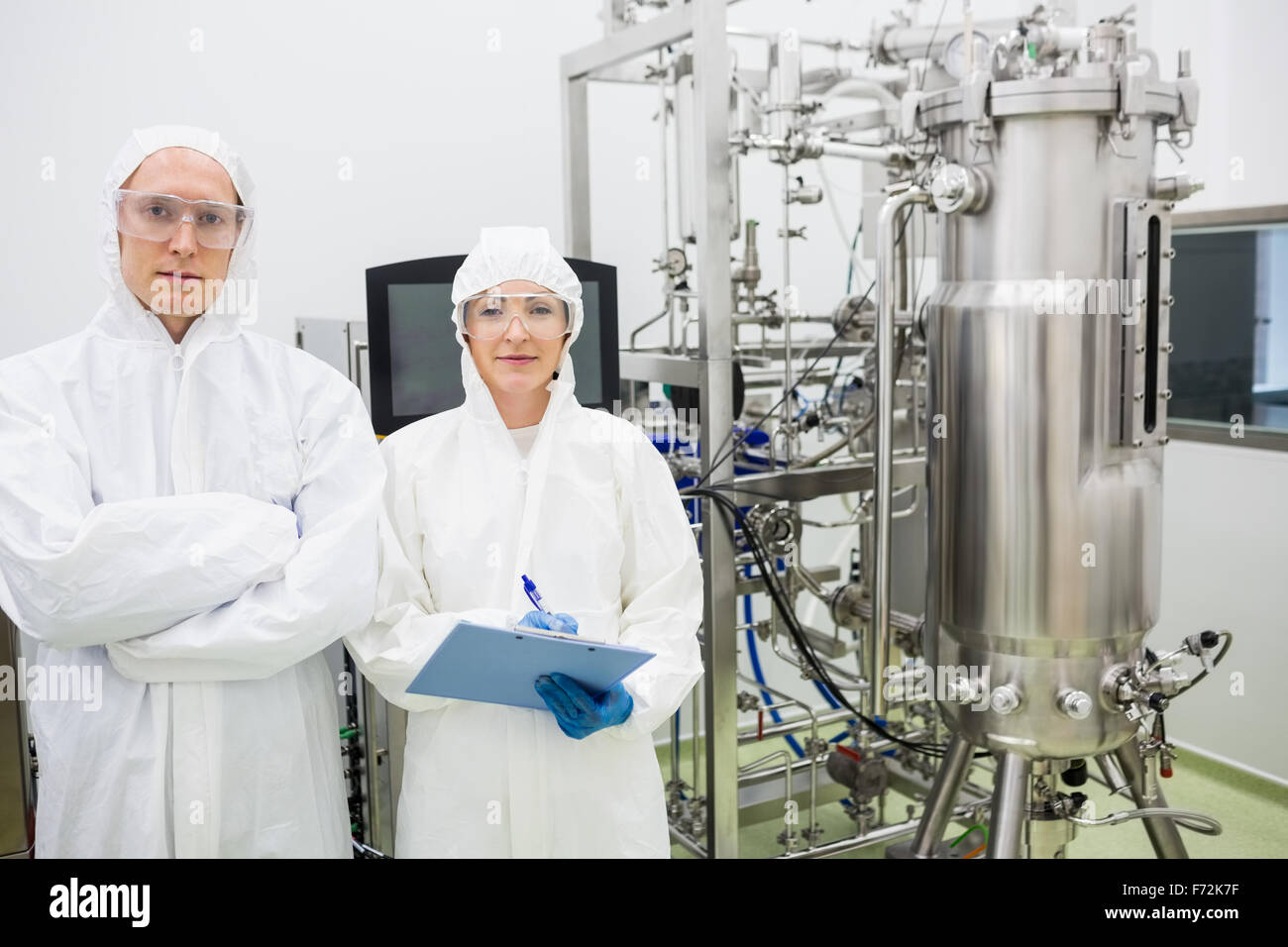 Scientists working with large vat Stock Photo - Alamy