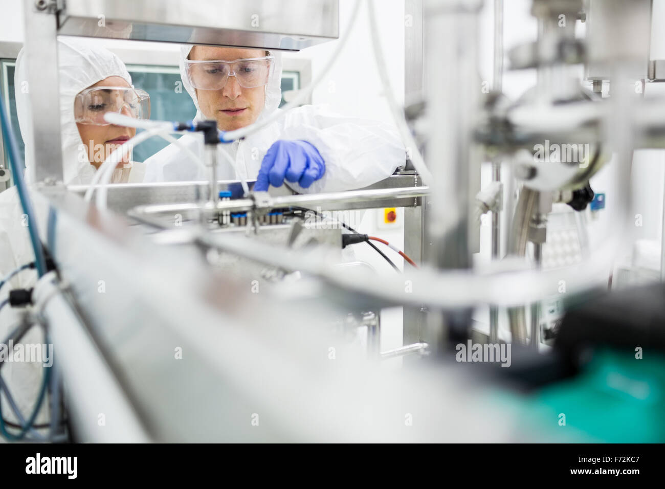 Scientists working with large vat Stock Photo - Alamy