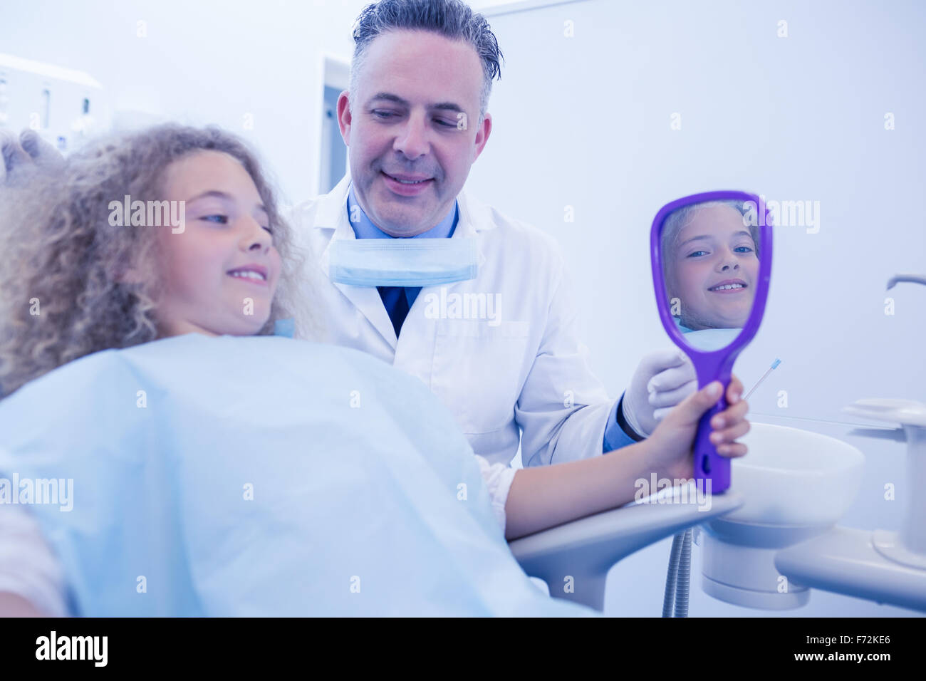 Pediatric dentist showing patient new smile Stock Photo - Alamy