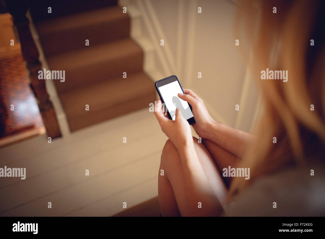Pretty woman using smartphone in the stairs Stock Photo - Alamy