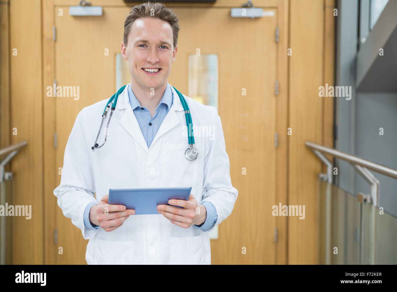 Young doctor smiling at camera Stock Photo - Alamy