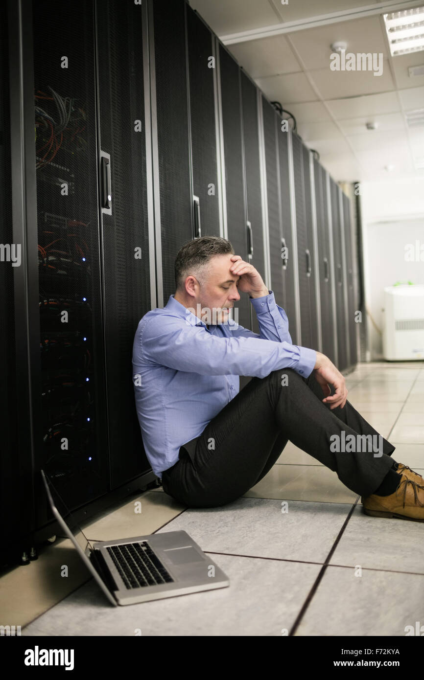 Technician feeling the pressure in server room Stock Photo - Alamy