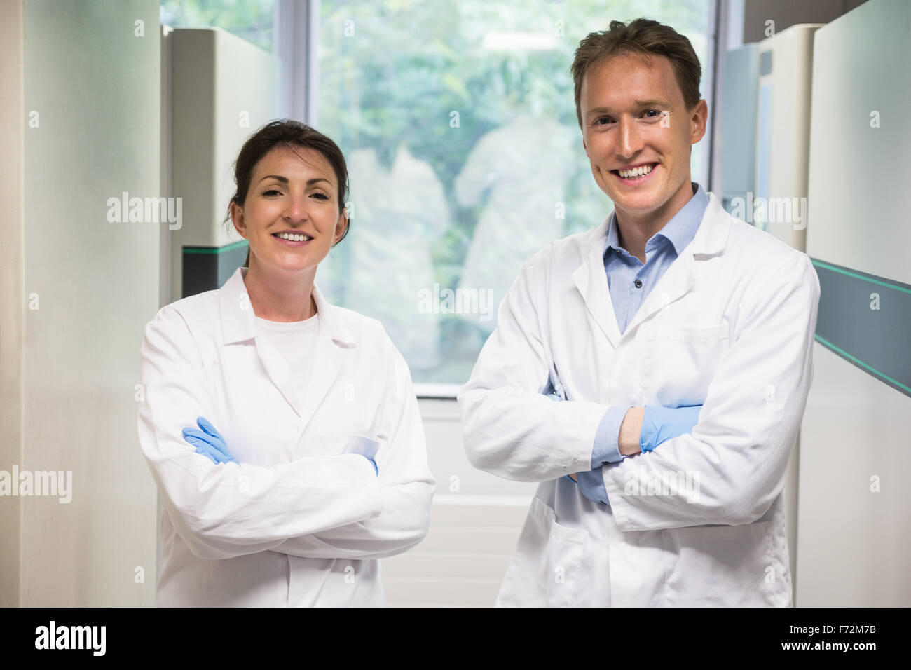 Two scientists smiling at camera Stock Photo - Alamy