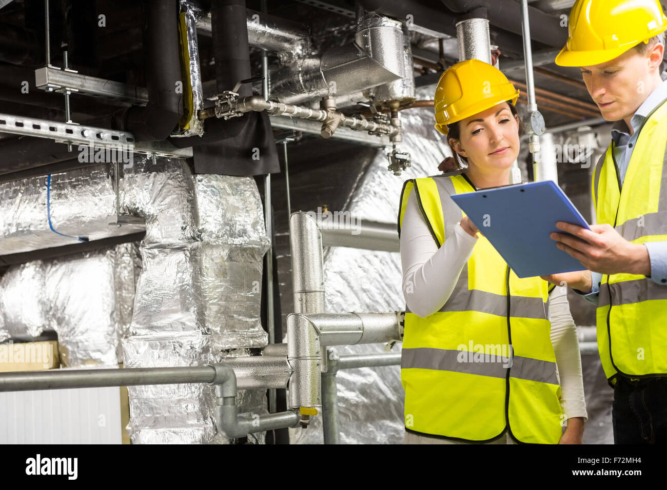 Engineers checking the temperature pipes Stock Photo - Alamy