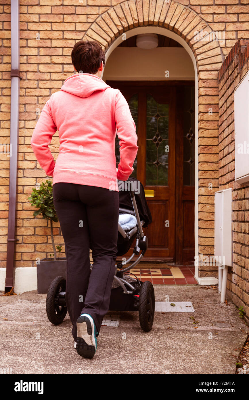 Mother pushing pram Stock Photo - Alamy
