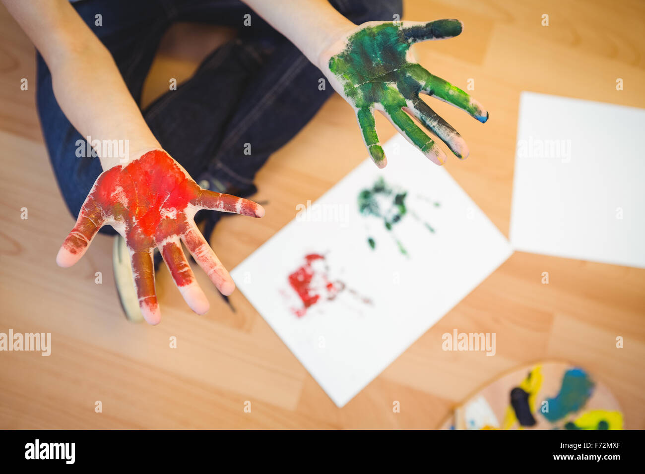 Boy showing his green and red painted hands Stock Photo - Alamy